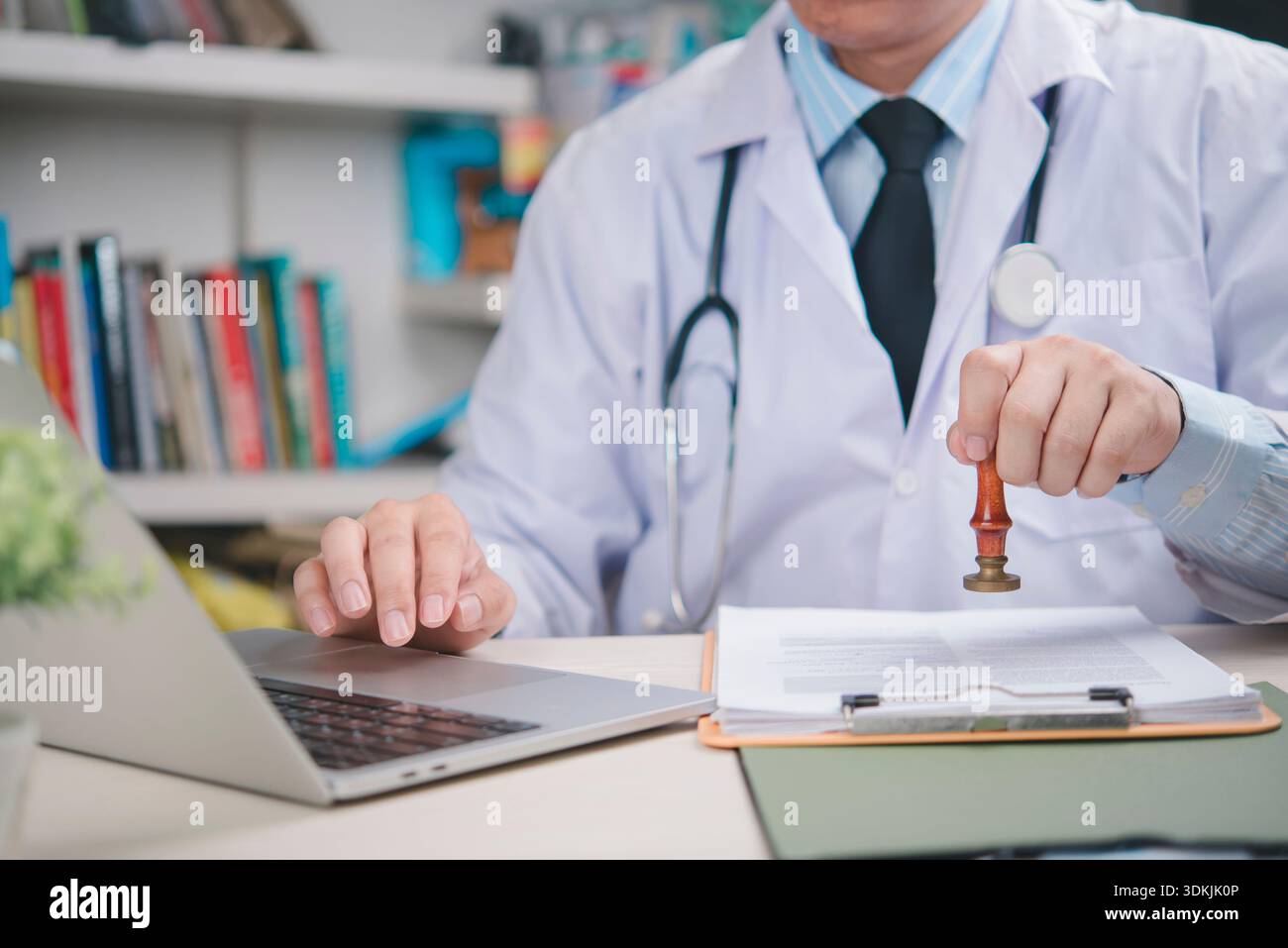 Doctor stamping medical document in office, confirming approval ...