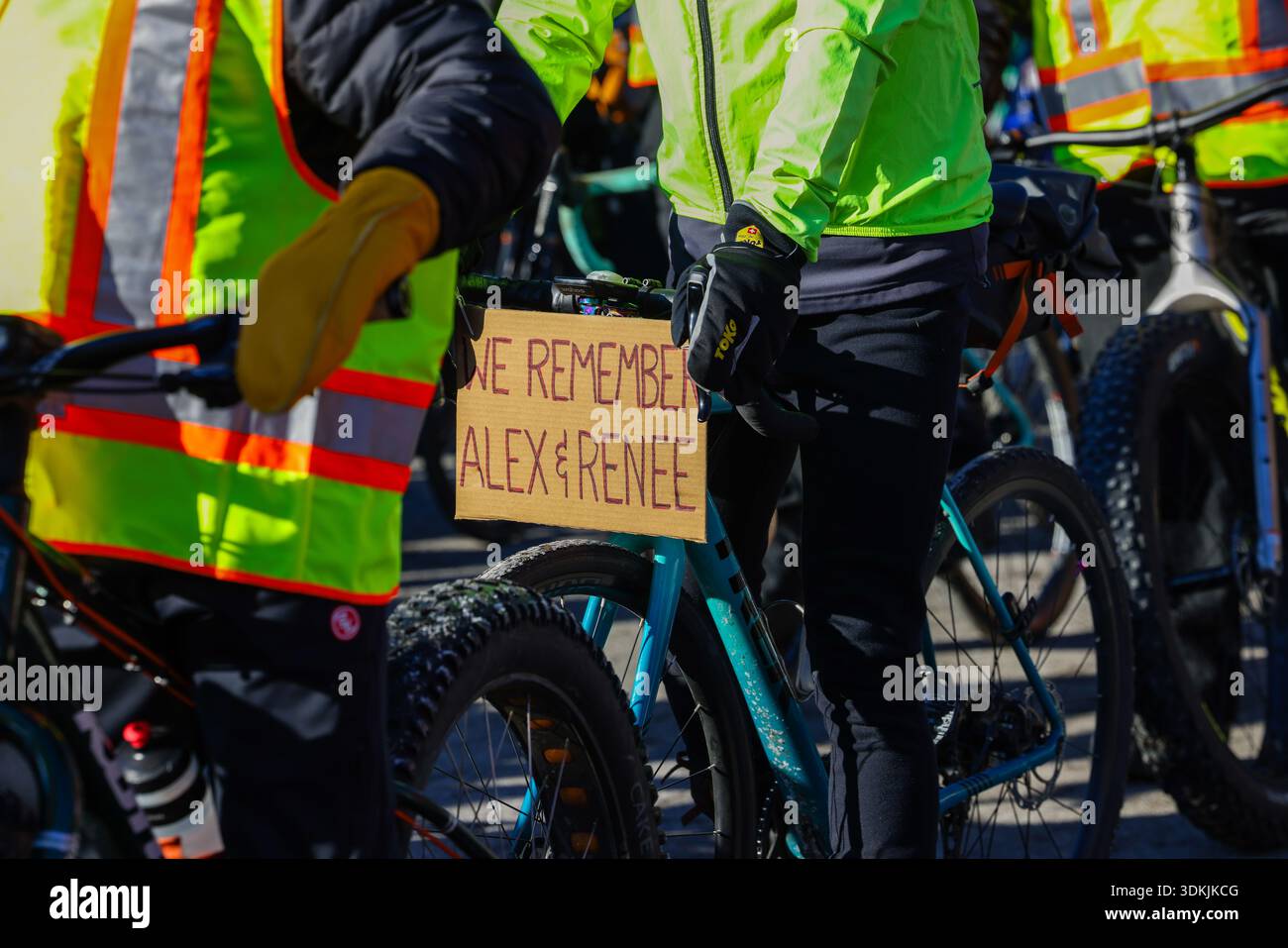 Cyclists in the Alex Pretti Memorial Bike Ride with a sign We Remember ...
