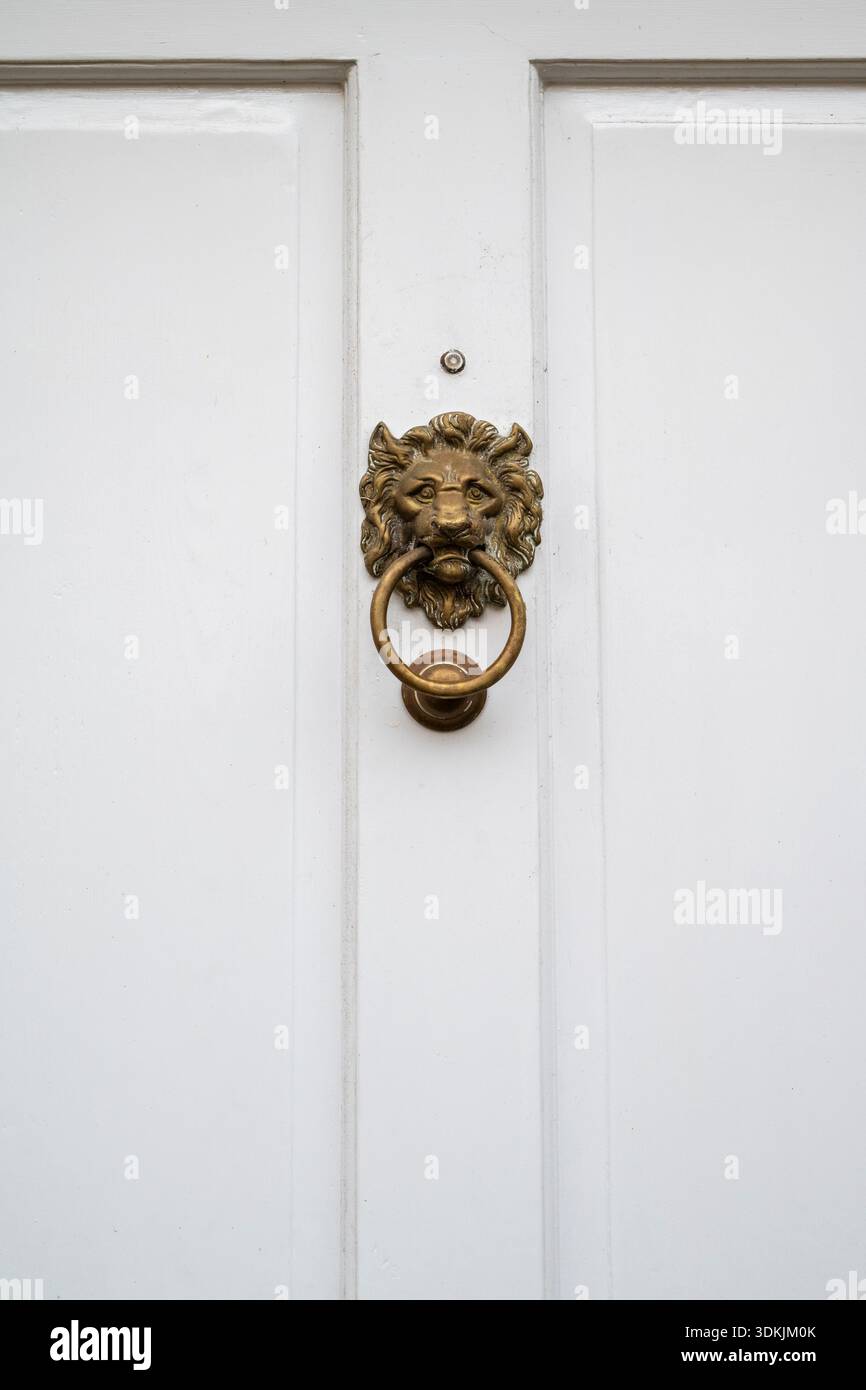 Brass Lion head door knocker on a black house door. Blockley, Cotswolds ...