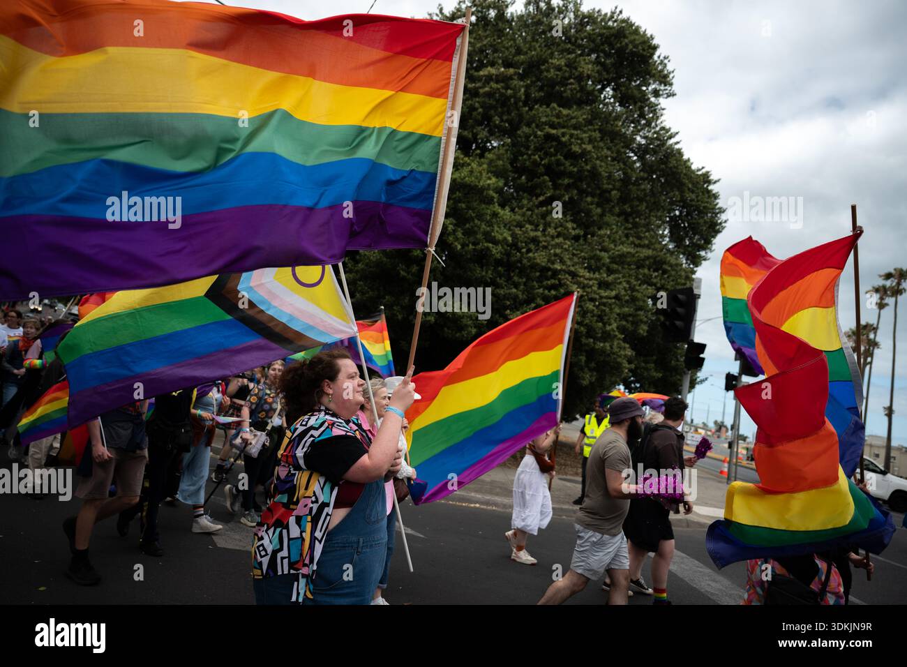 Participants march while holding pride flags during the annual Midsumma ...