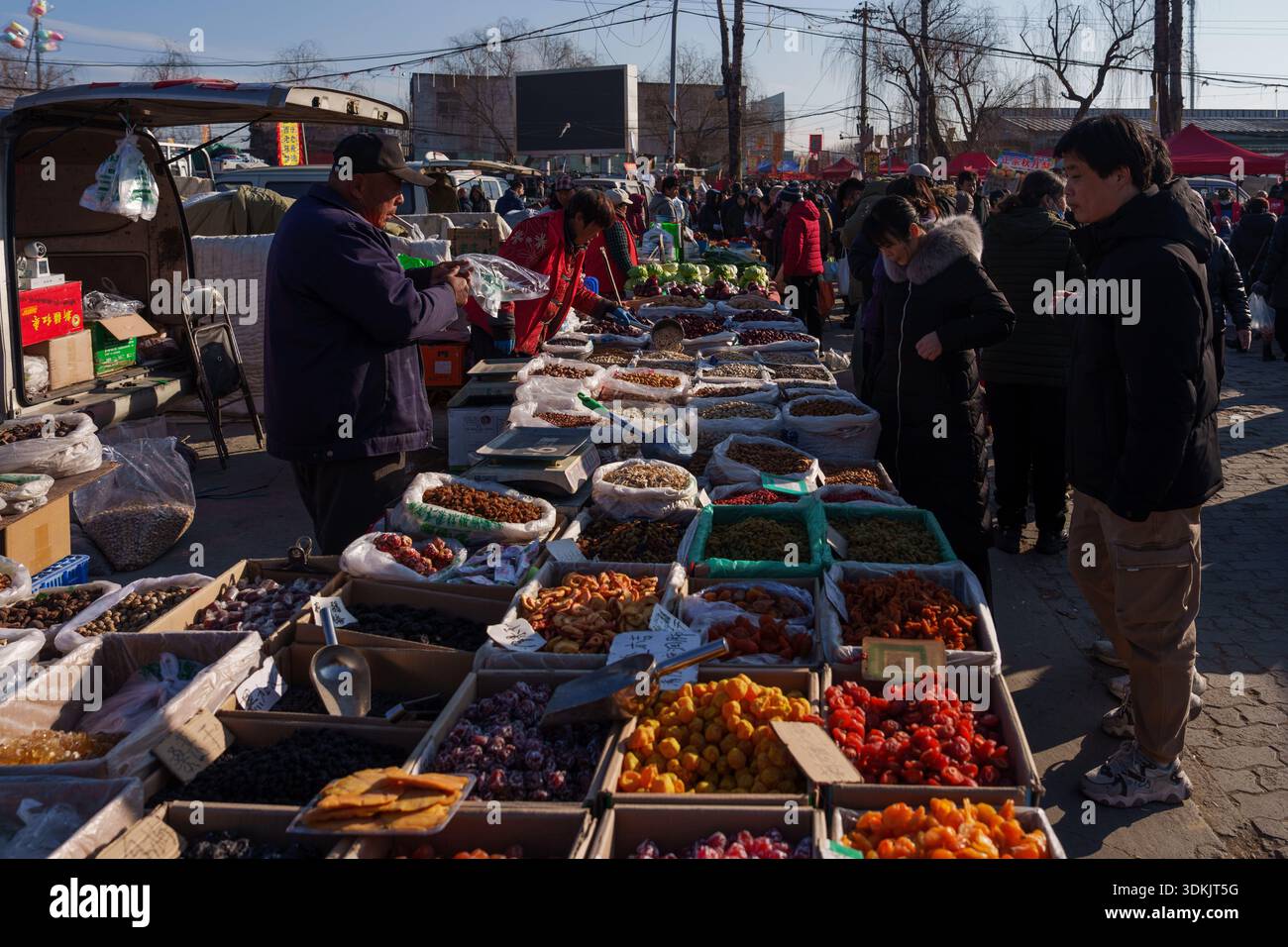 Shoppers browse dried fruits, nuts and preserved foods at an open-air ...