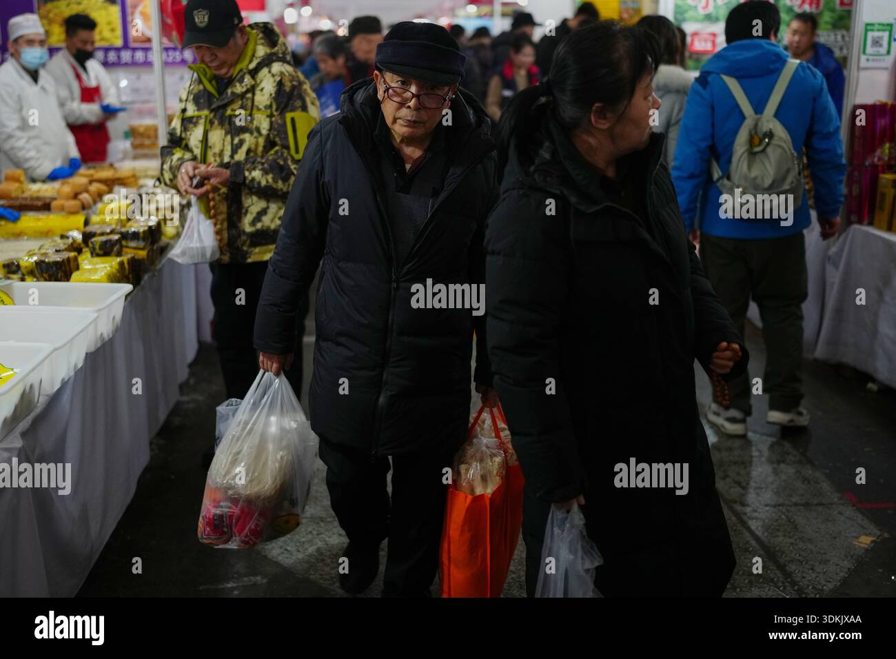 People shop at a New Year Bazaar setup for the upcoming Chinese Lunar ...