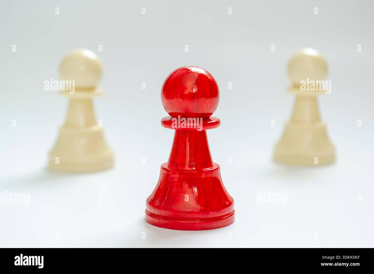 Standing red pawn positioned forward representing frontline leadership ...