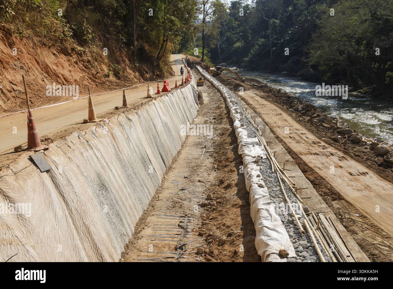 Construction of concrete retaining wall for erosion control on rural ...