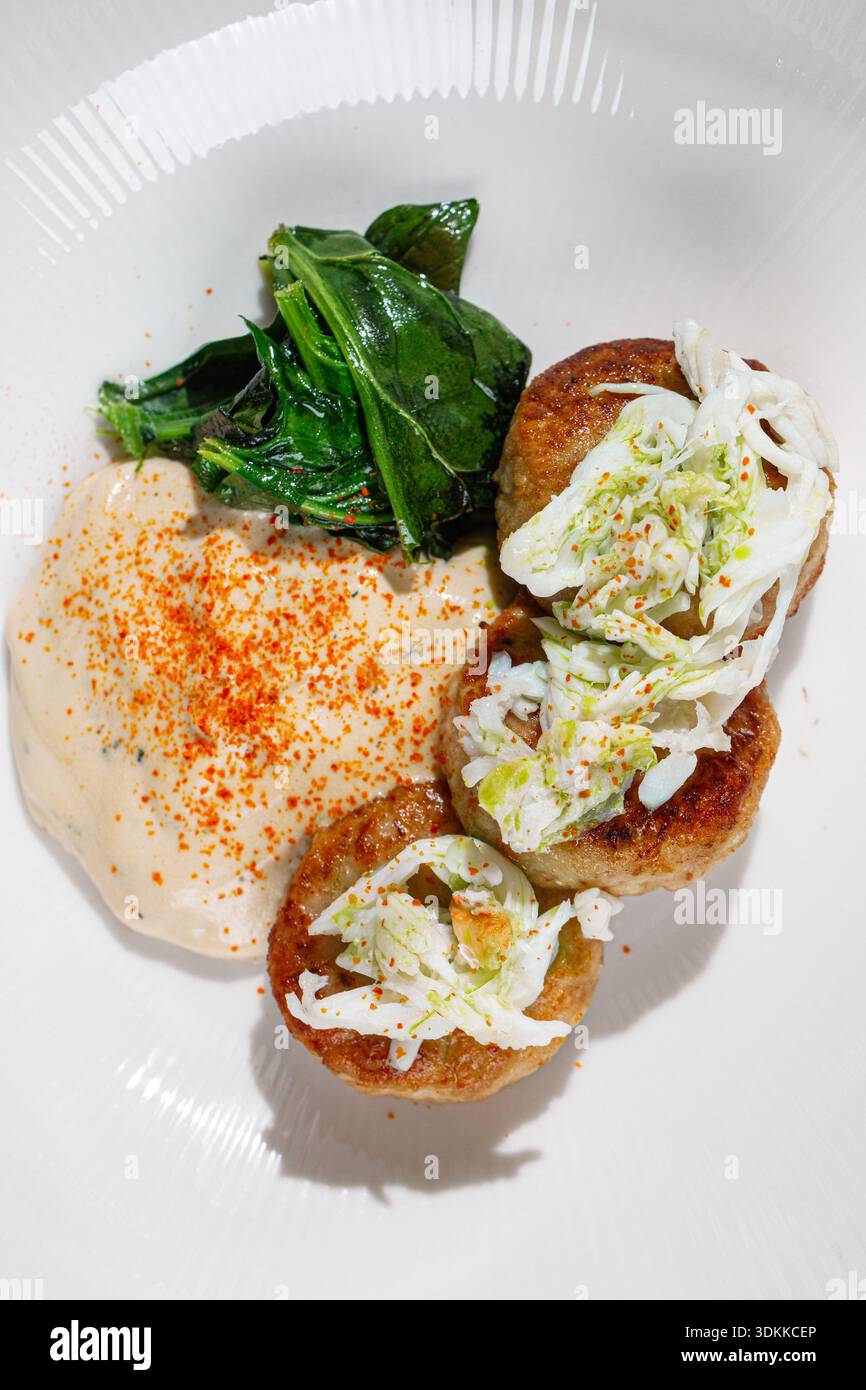 Chicken patties with potato mousse and greens Stock Photo - Alamy