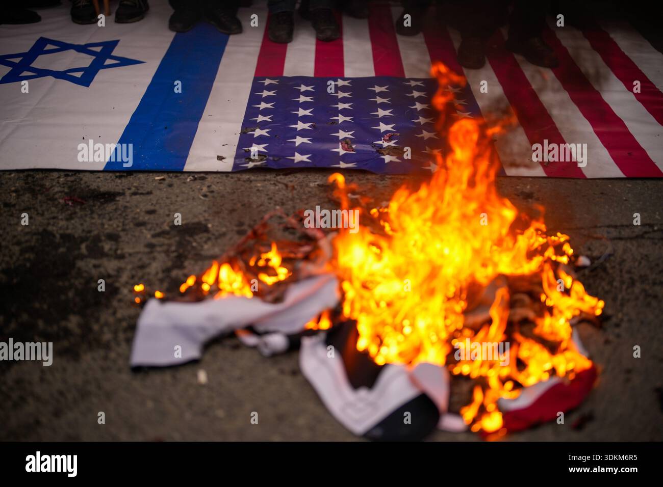 People stand onto U.S. and Israel flags, outside the U.S. Consulate in ...