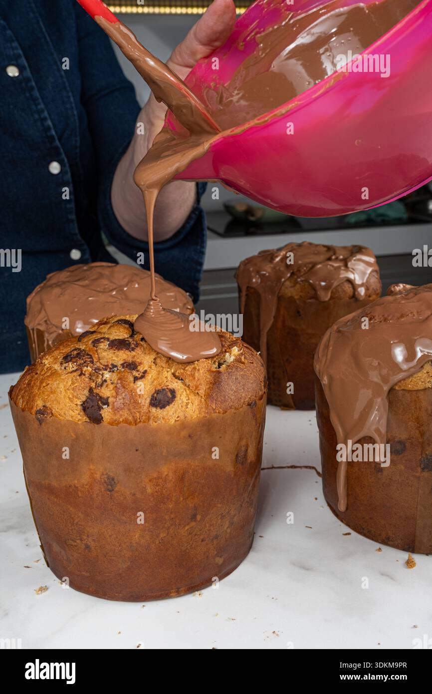 Confectioner applying chocolate frosting panettone hi-res stock ...