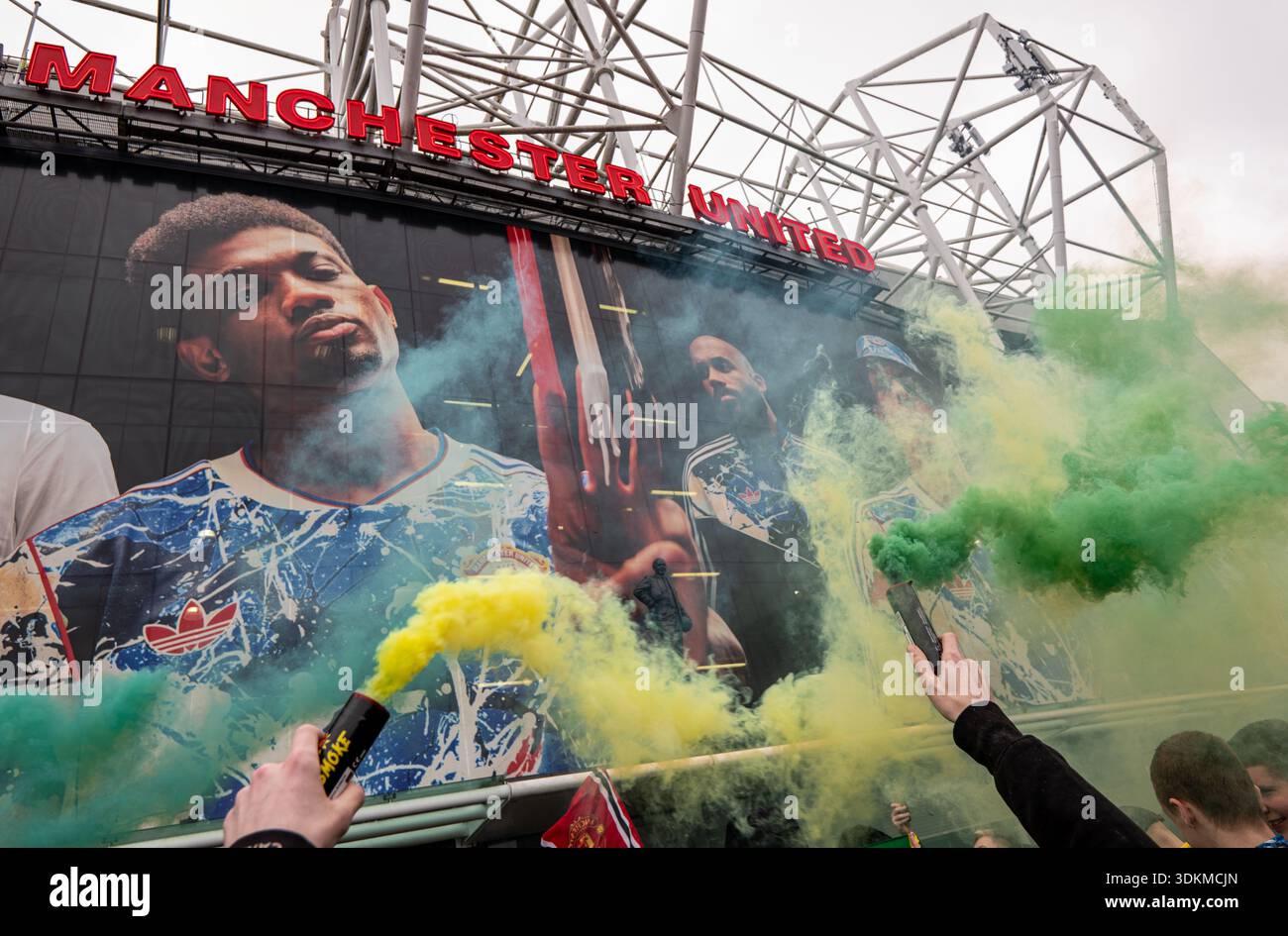 Manchester United supporters, many wearing clown masks, and letting off ...