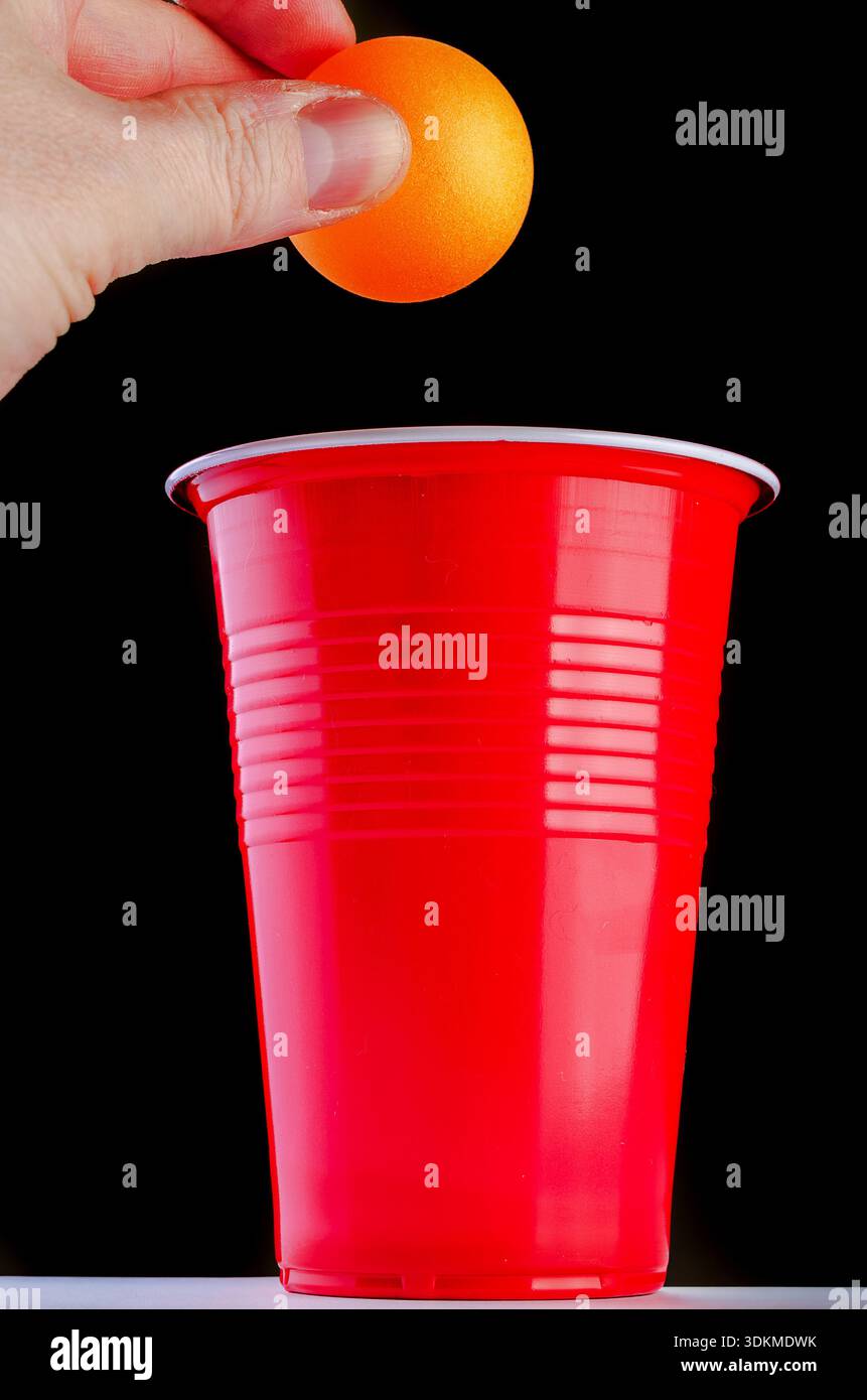 Hand dropping orange ping hi-res stock photography and images - Alamy