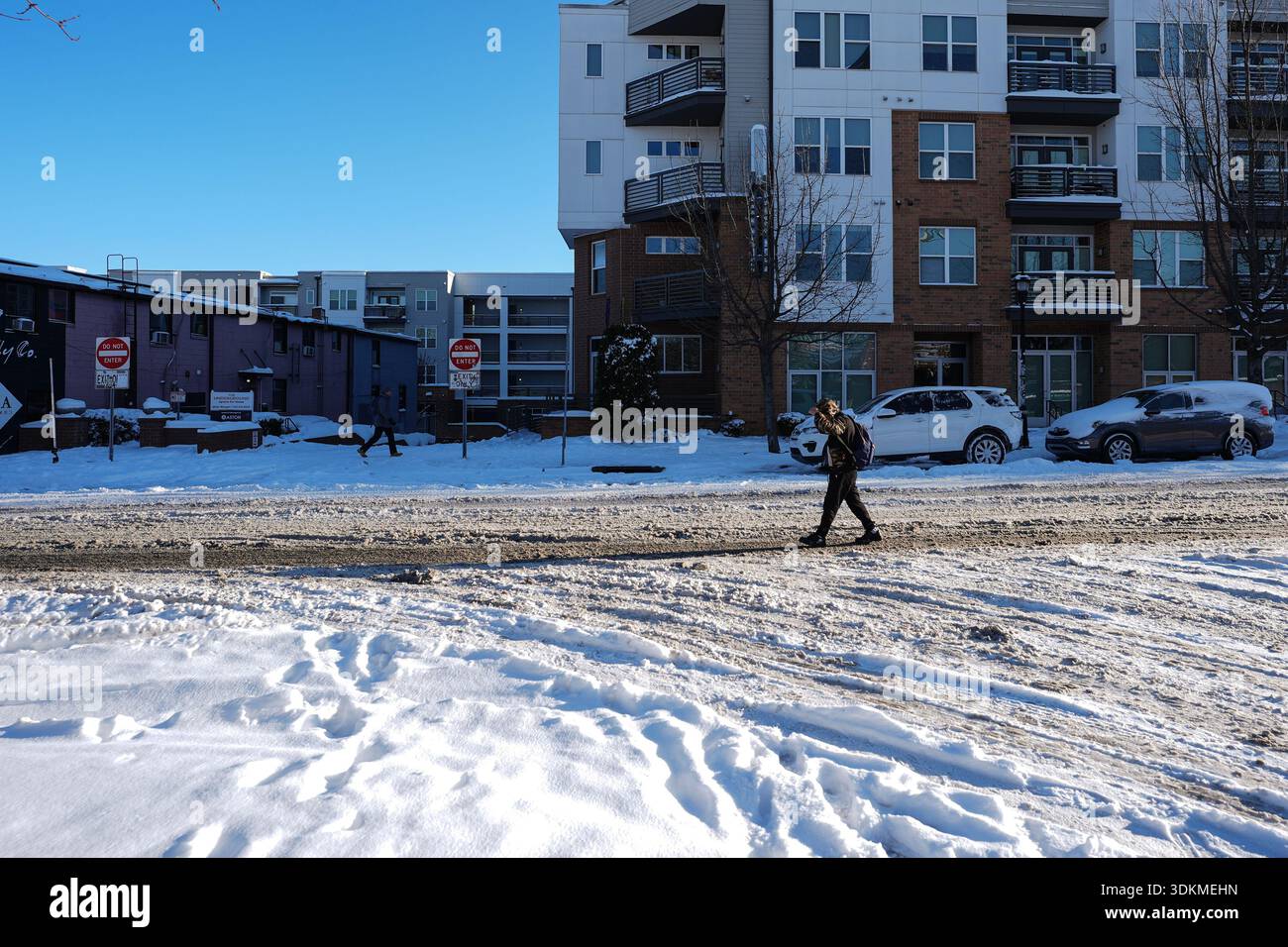 Residents walk through snow covered streets, Sunday, Feb 1, 2026, in ...