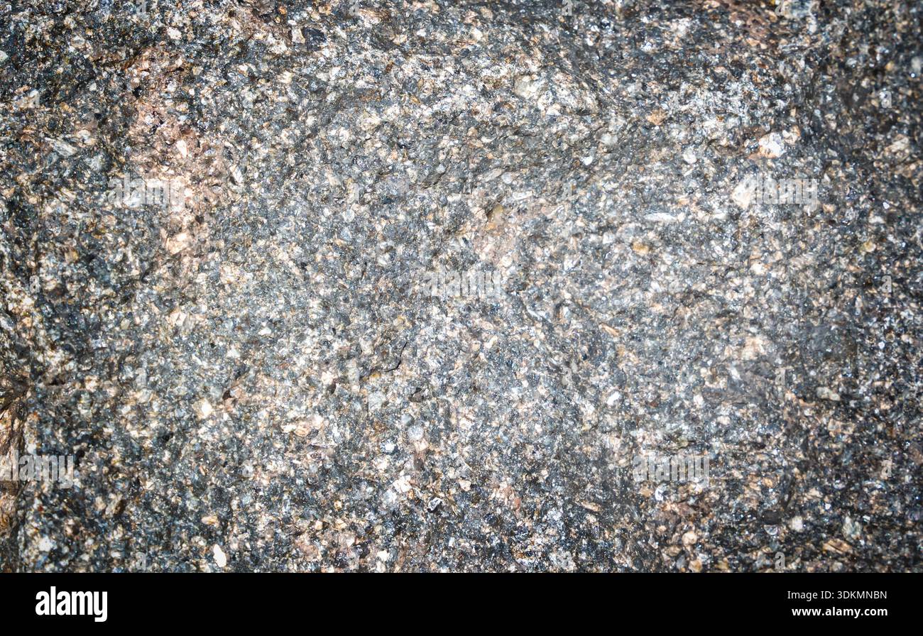Close-up view of textured granite rock surface displaying various ...