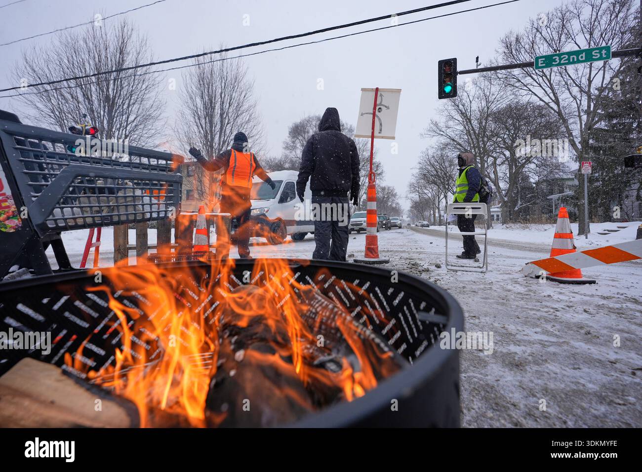 People stand near a blockade set up to deter federal immigration ...