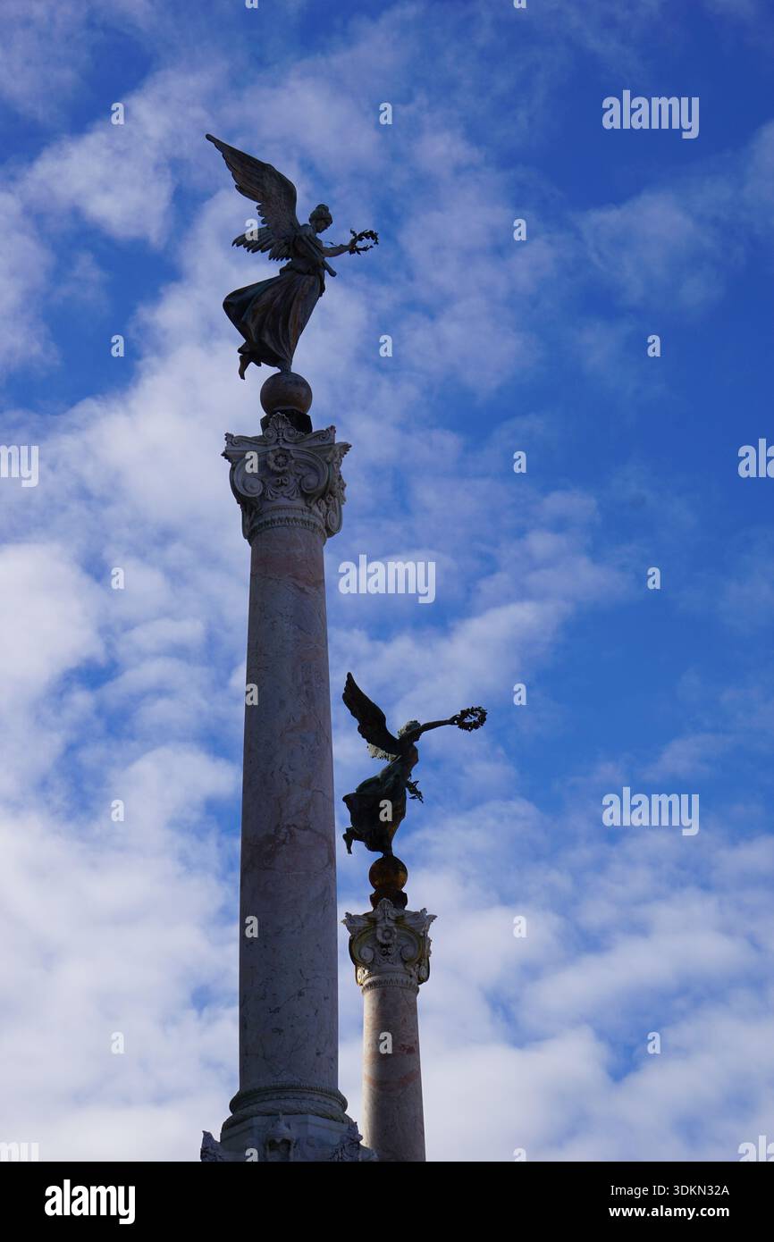 Vertical image of two classical bronze statues depicting angels ...