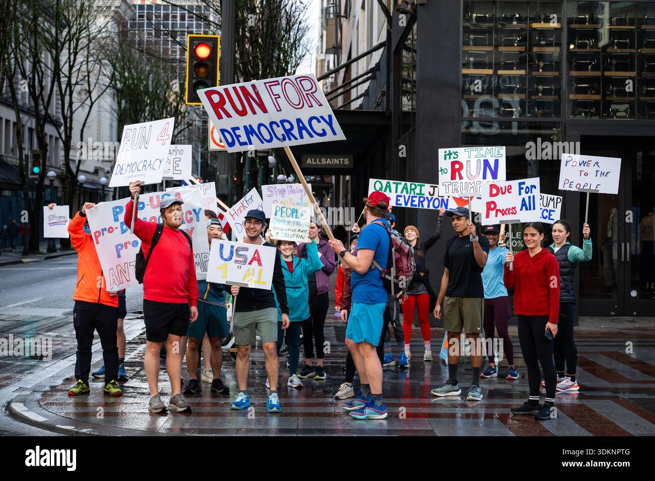 Seattle, USA. 1st Feb, 2026. A group of runners out with signs in the ...