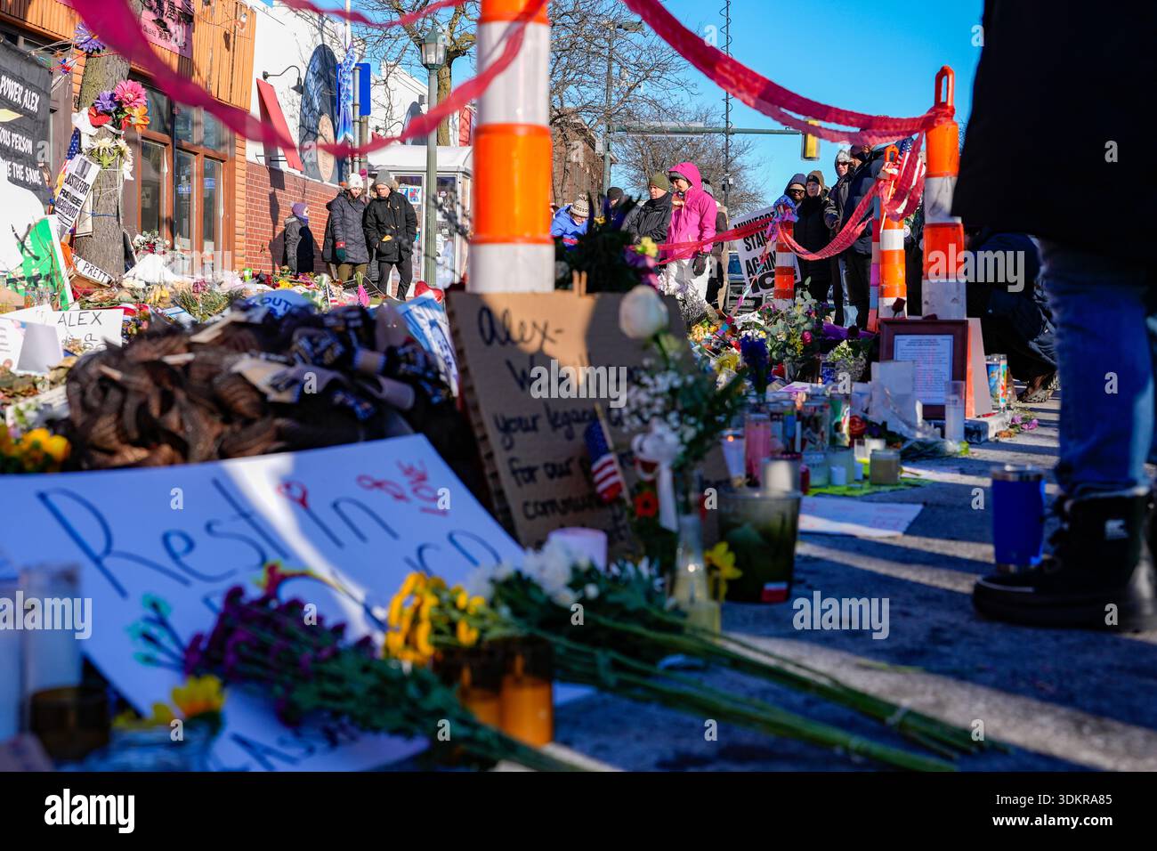 People seen visiting the Alex Pretti memorial site. Memorials continue ...