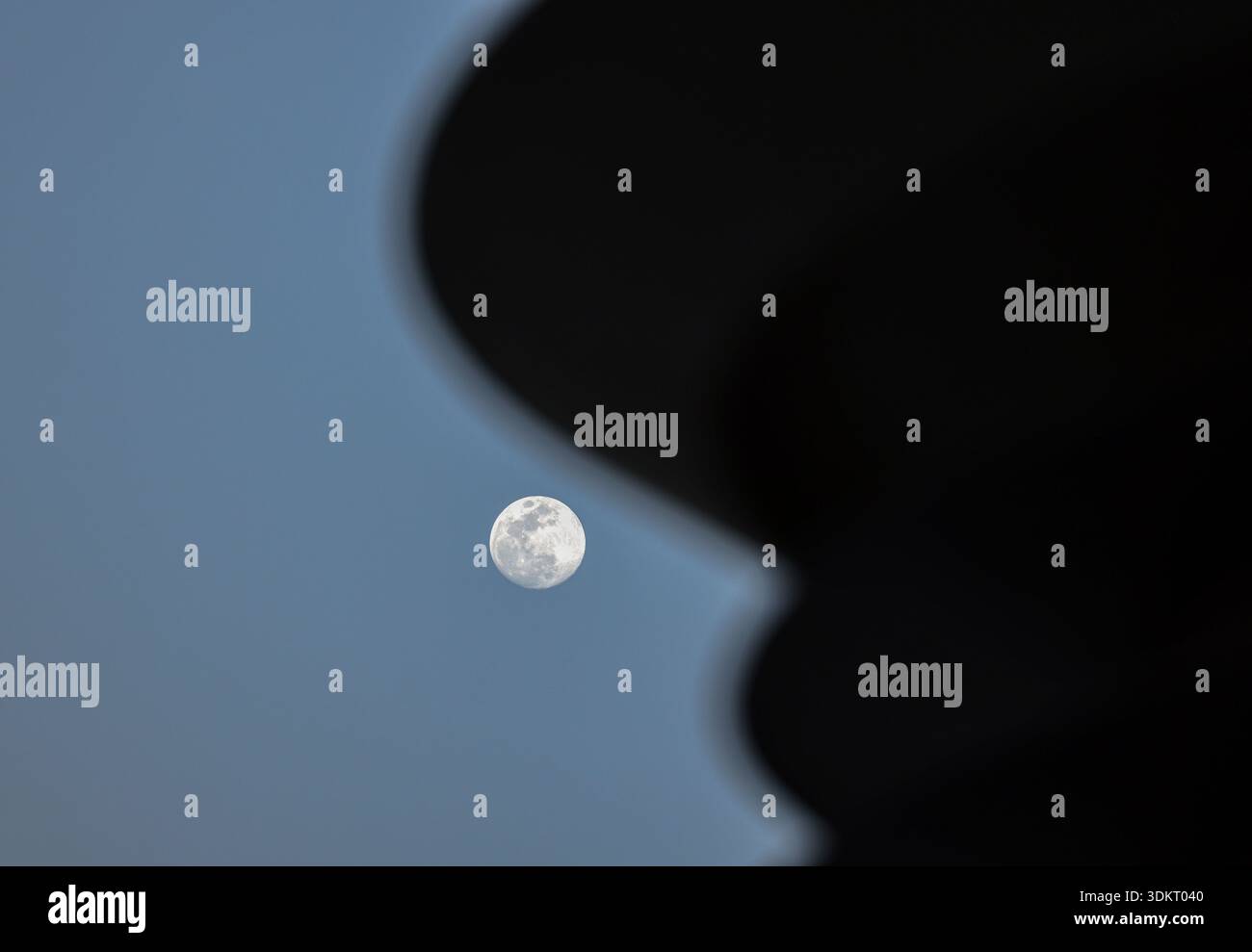 The moon appears as a full moon in the sky over Doha, the capital of ...