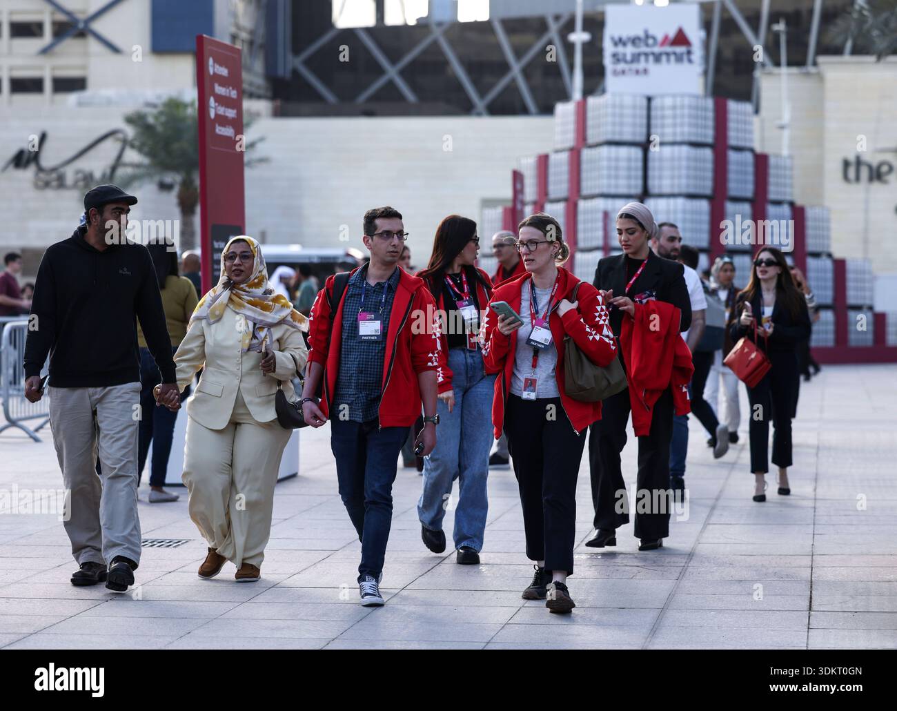 People walk past a model of Web Summit 2026, the world's largest ...