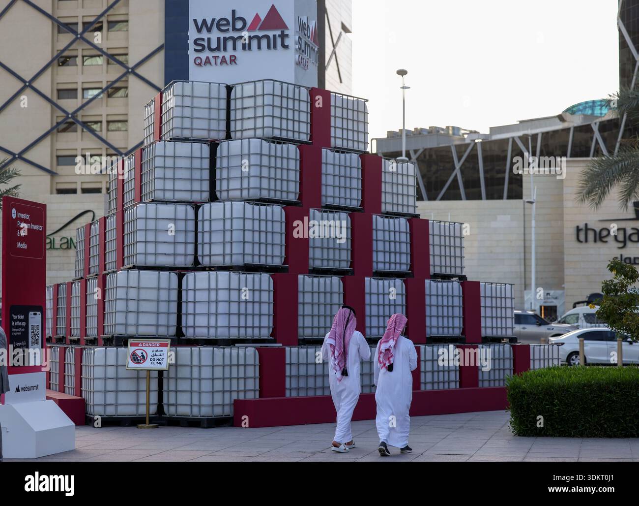 People walk past a model of Web Summit 2026, the world's largest ...