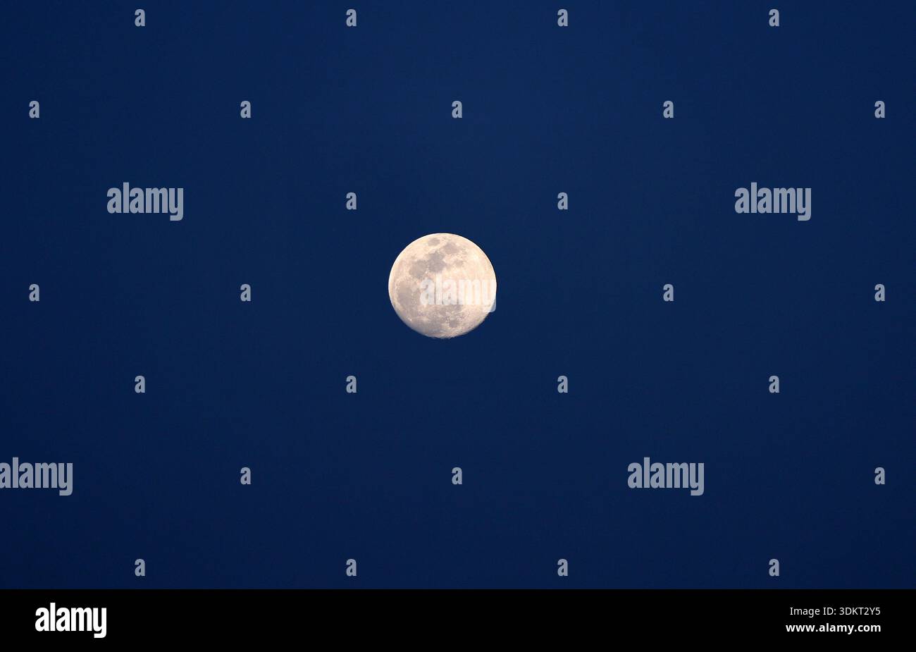 The moon appears as a full moon in the sky over Doha, the capital of ...