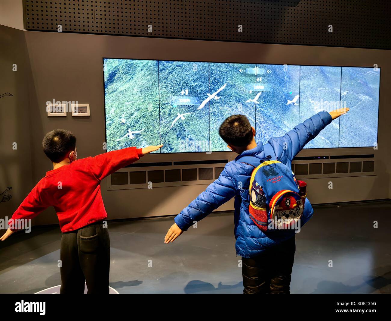 Visitors interact with exhibits at the renovated Shanghai Science and ...