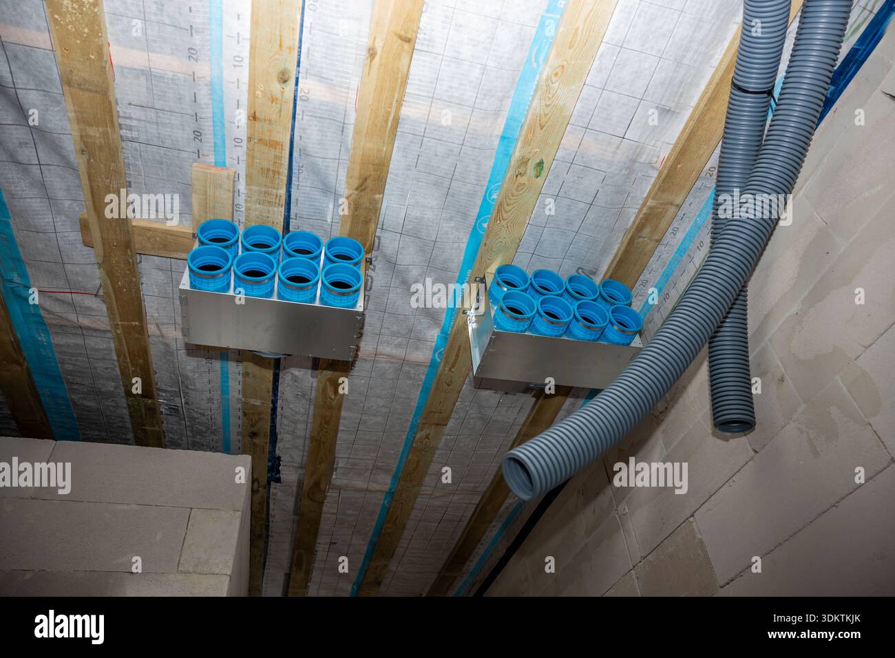 Interior ceiling under construction with wooden beams, insulation, and ...