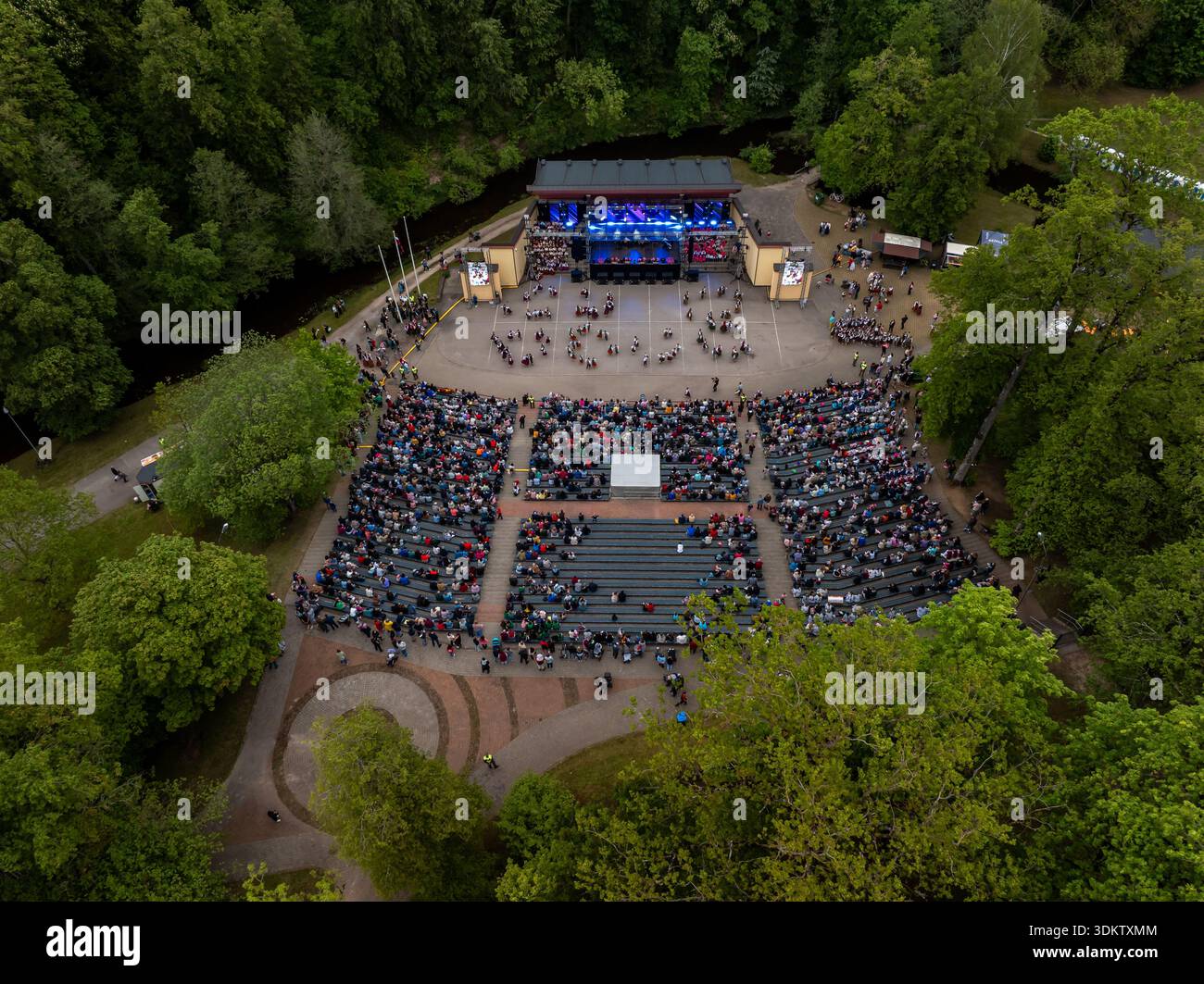 An aerial view of an outdoor amphitheater surrounded by trees ...