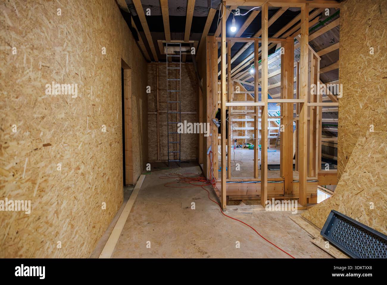Partially built attic shows exposed studs, OSB walls, and rafters with ...