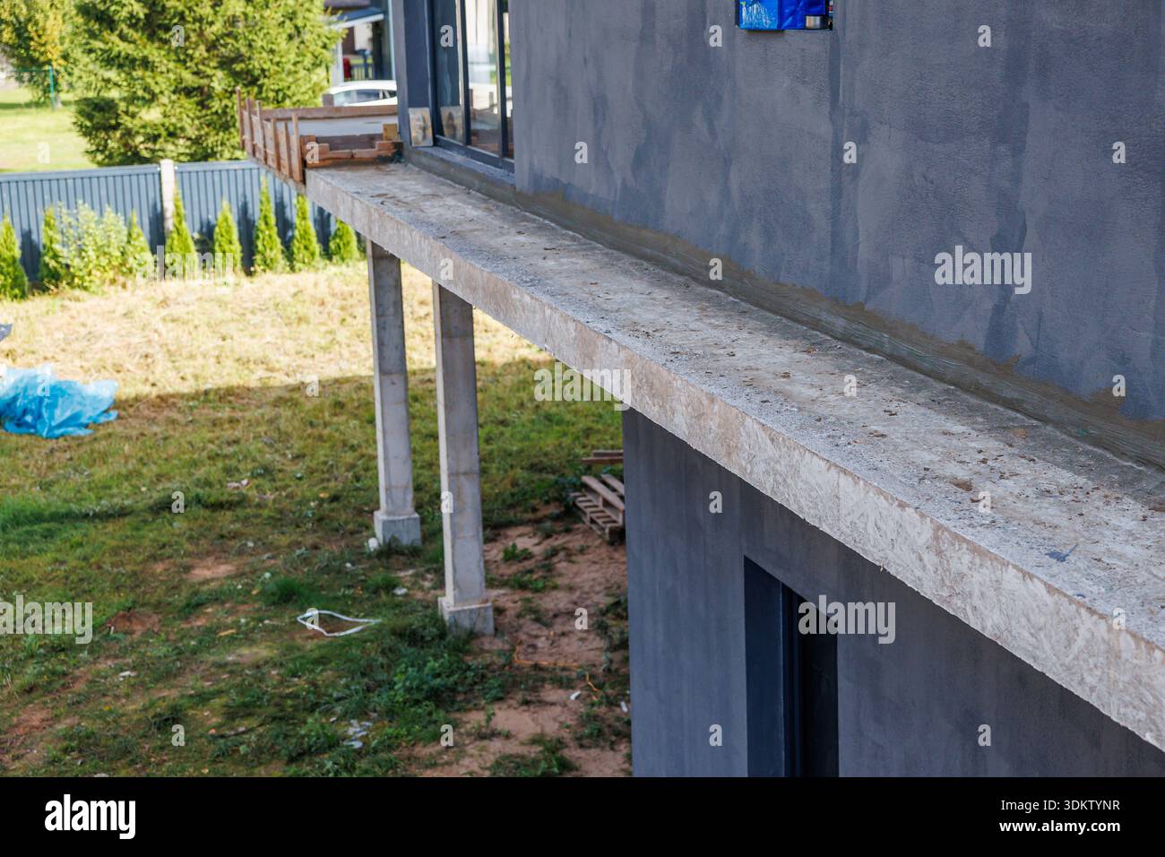An unfinished building with a gray exterior and concrete ledge ...