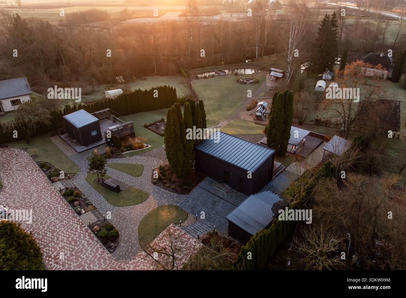 Early morning aerial of a planned countryside homestead with black clad ...