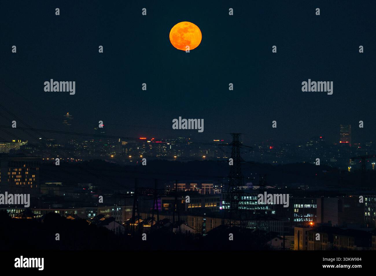 A full moon rises over Beijing, China, Monday, Feb. 2, 2026. (AP Photo ...