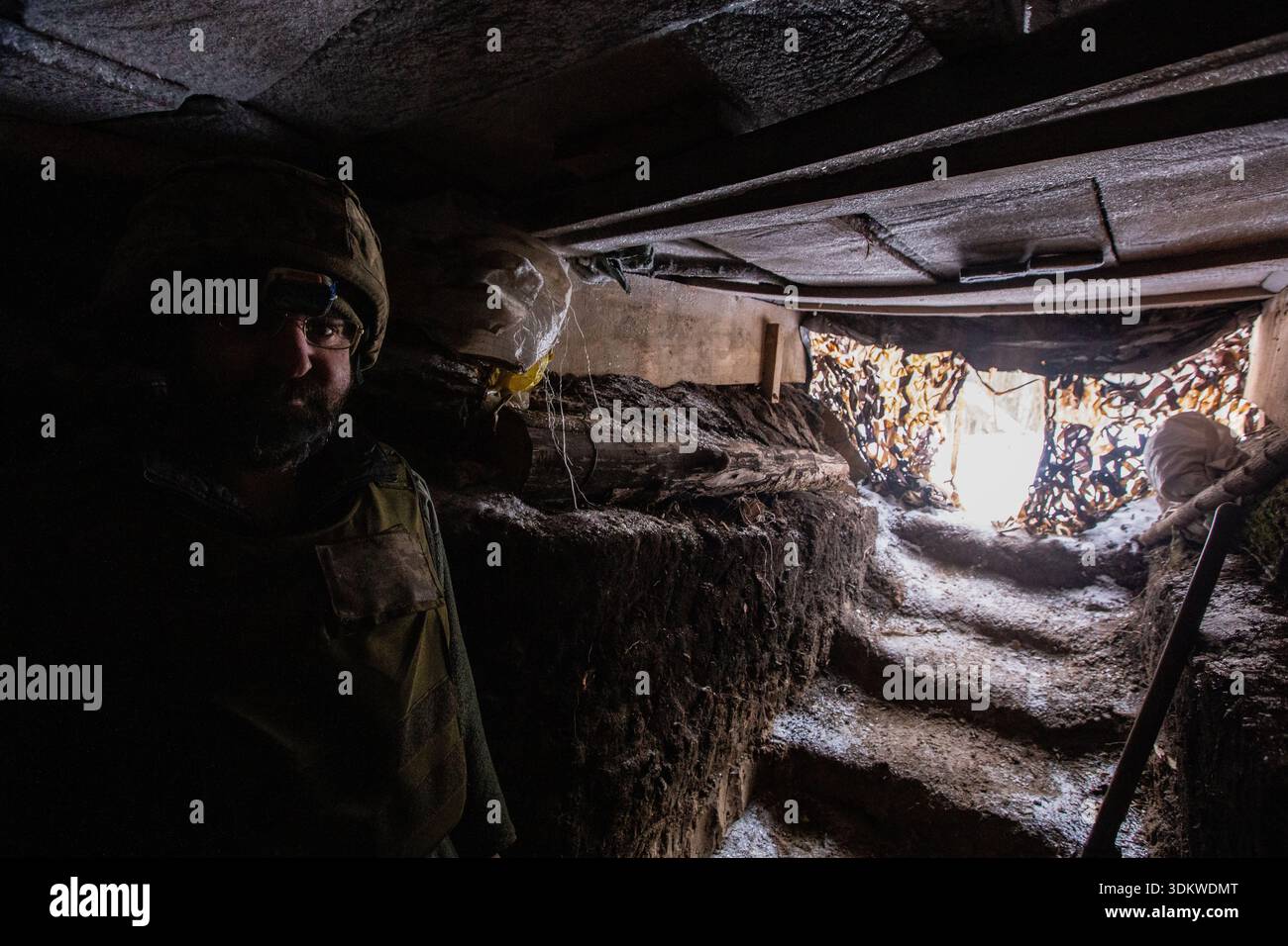 Ukrainian soldiers' military shelter on the Sumy front. In the cold of ...