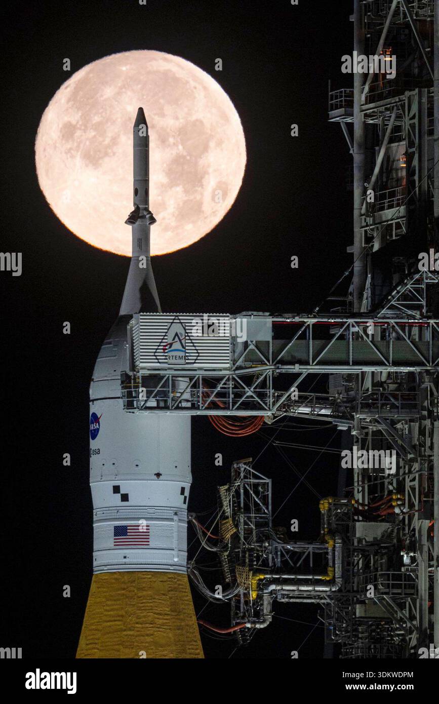 A full moon is seen shining over NASA’s SLS (Space Launch System) and ...