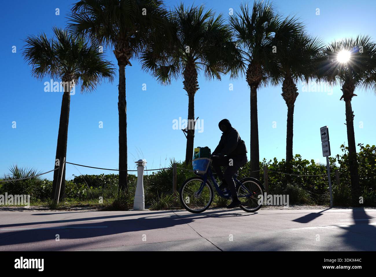A bicyclist braves the cold temperatures Monday, Feb. 2, 2026, in Miami ...