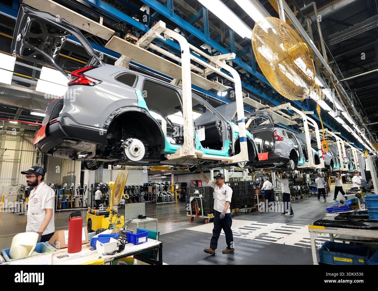 Honda employees work along the vehicle assembly line in Alliston, Ont ...