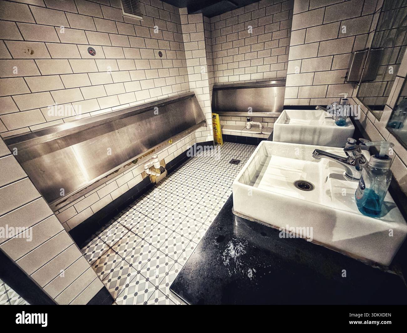 Public gents male toilet loo metal trough empty no-one nobody tiles in ...