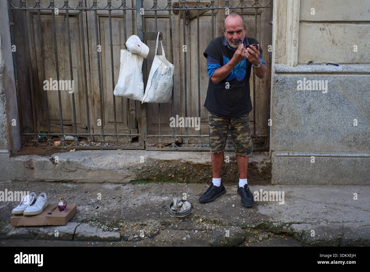 David Gutierrez, who said he is homeless, shaves in the street in ...