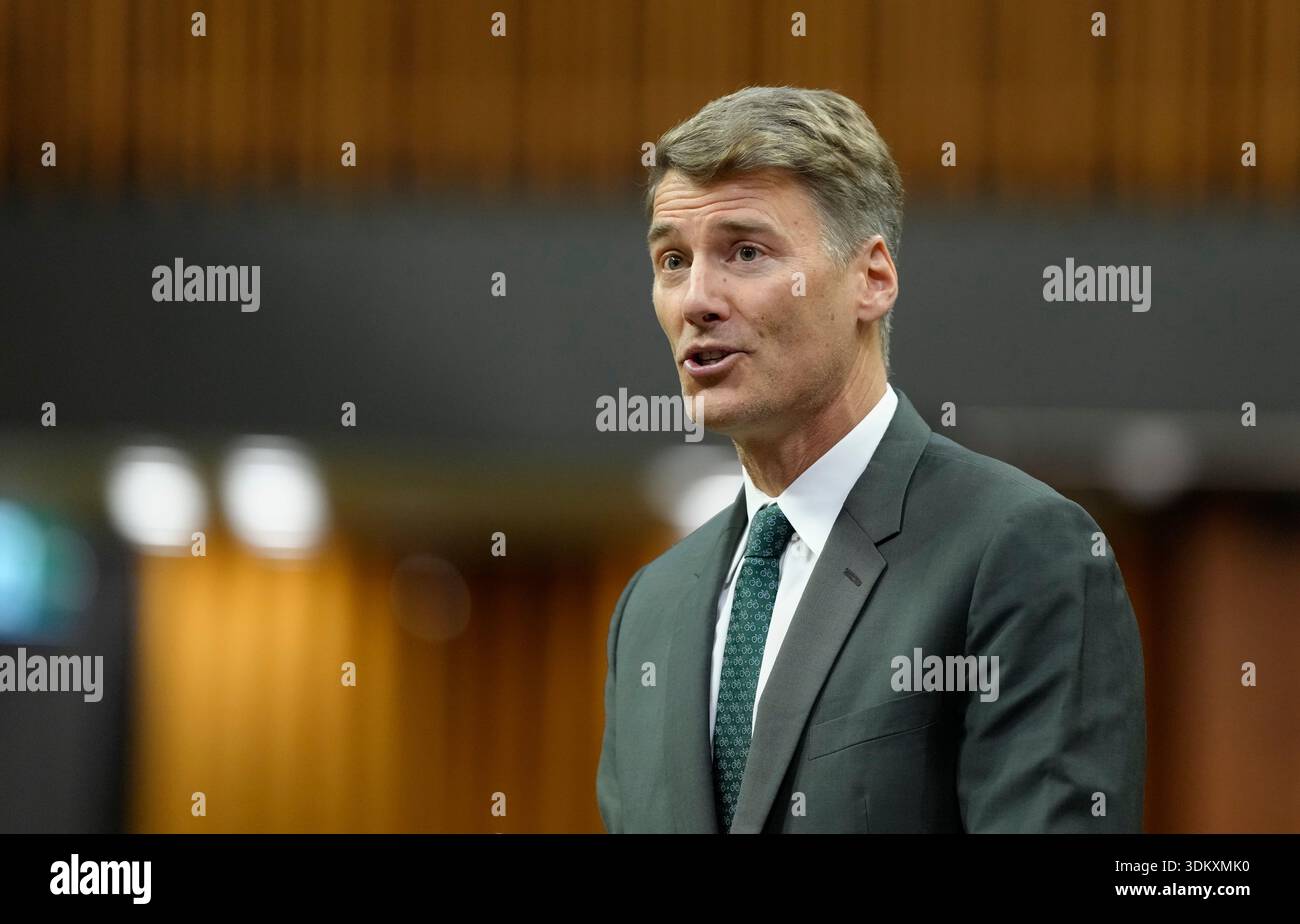 Housing and Infrastructure Minister Gregor Robertson rises during ...