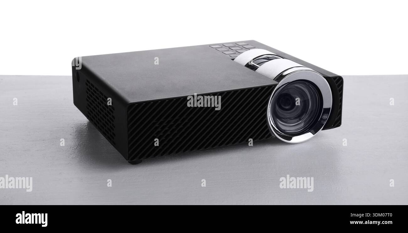 Modern video projector on grey table against white background Stock ...