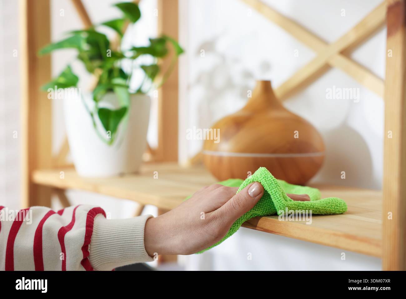 Woman wiping wooden shelf with microfiber cloth at home, closeup Stock ...