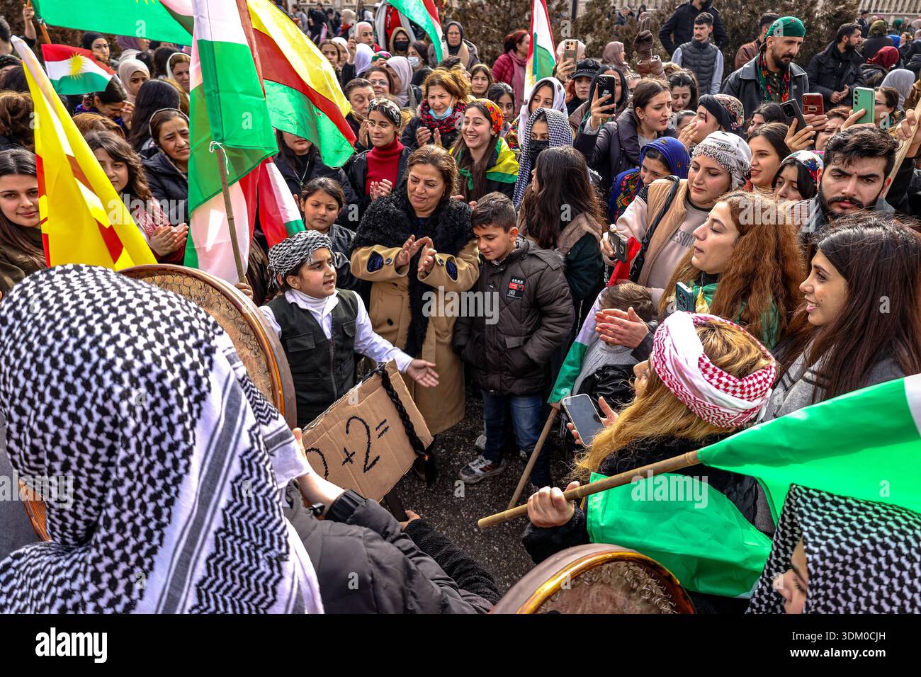 Kurds clap and wave Kurdistan flags during a demonstration in Qamishli ...