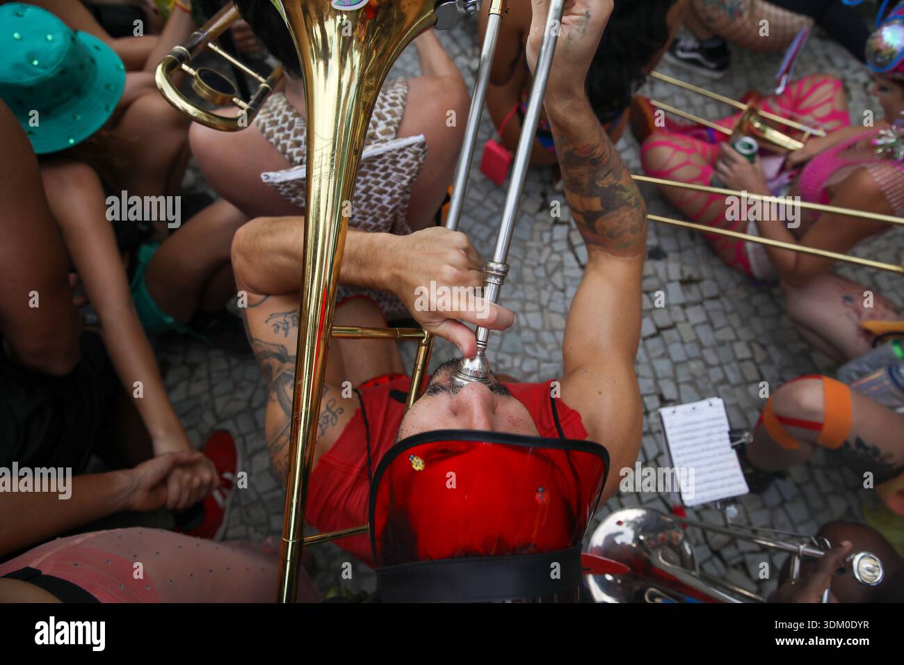 A musician plays a trumpet in a carnival bloco in Rio de Janeiro. The ...