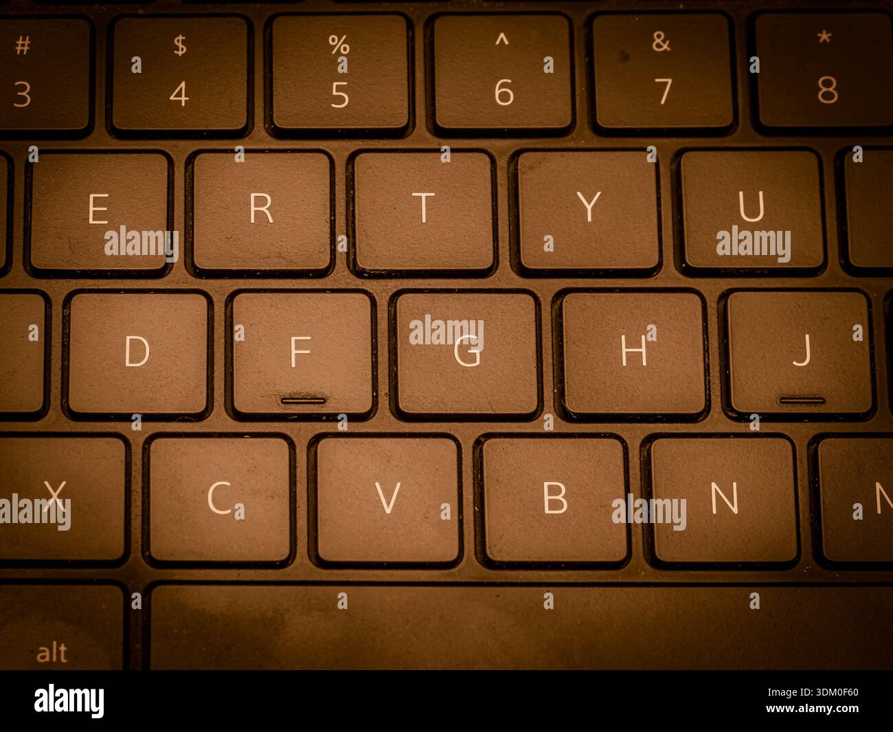 Macro top-down view of a QWERTY laptop keyboard with black keys and ...