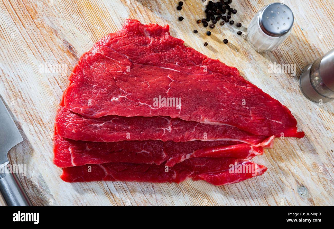 Uncooked beef fillet with black pepper on table Stock Photo - Alamy