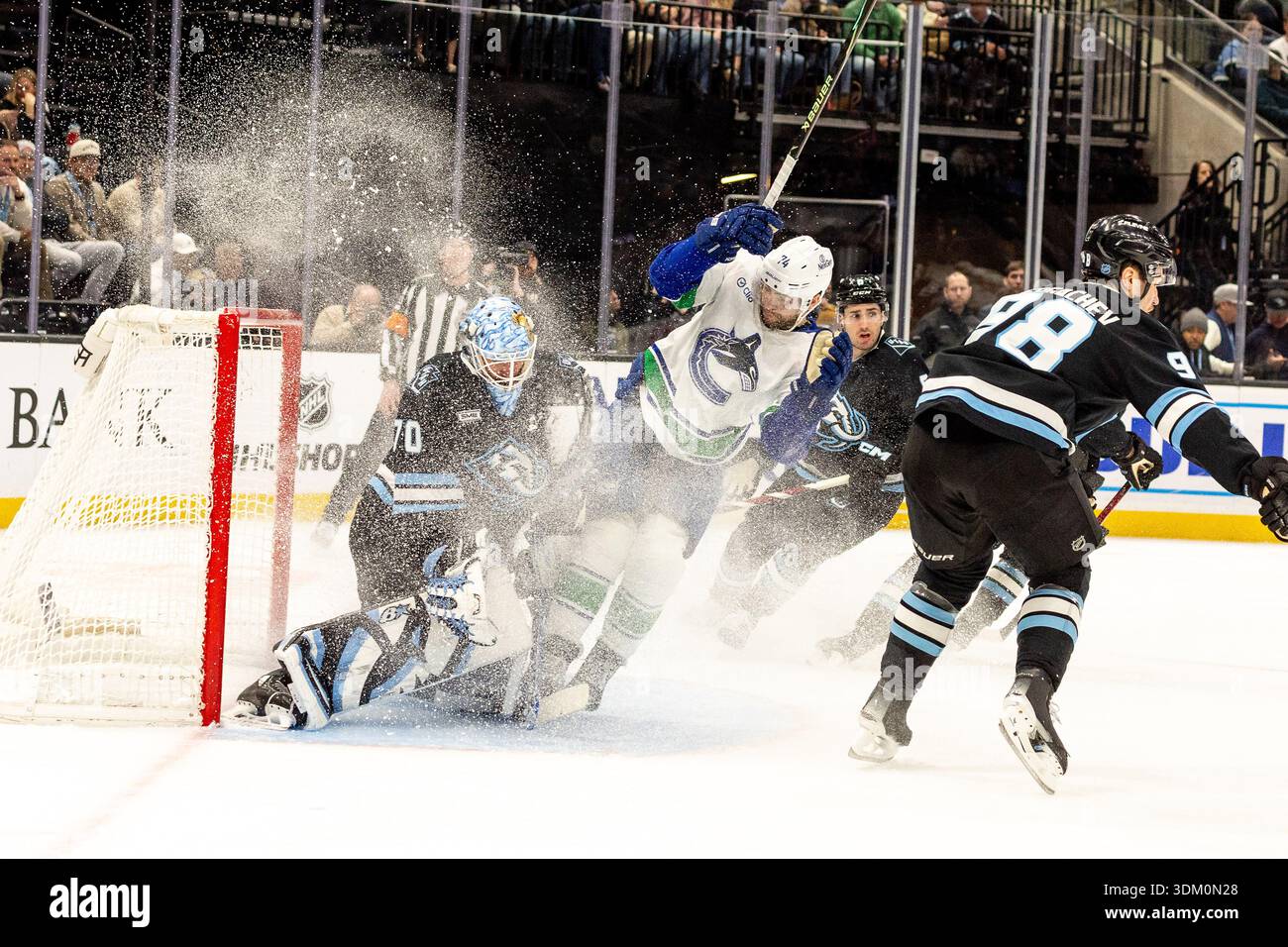 Vancouver Canucks left wing Jake DeBrusk (74) brings the puck in ...