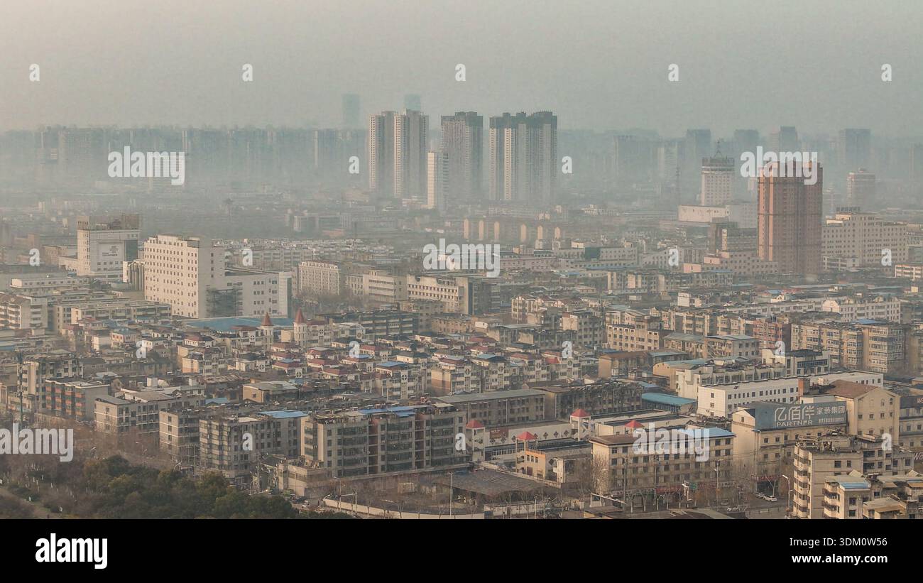 An expansive, hazy cityscape stretching to the horizon, where a ...