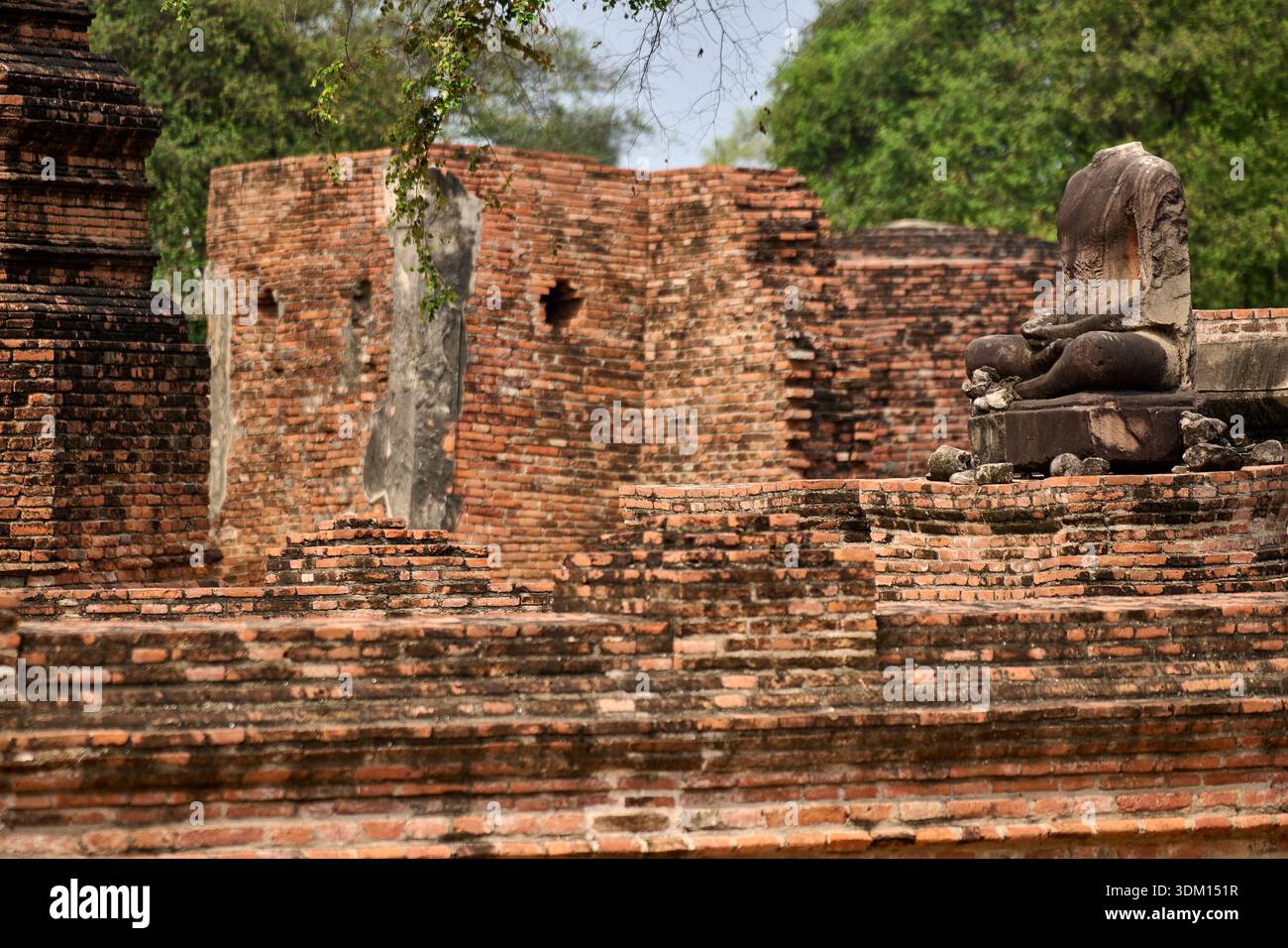 Headless stone Buddha statue among brick ruins in Ayutthaya Stock Photo ...
