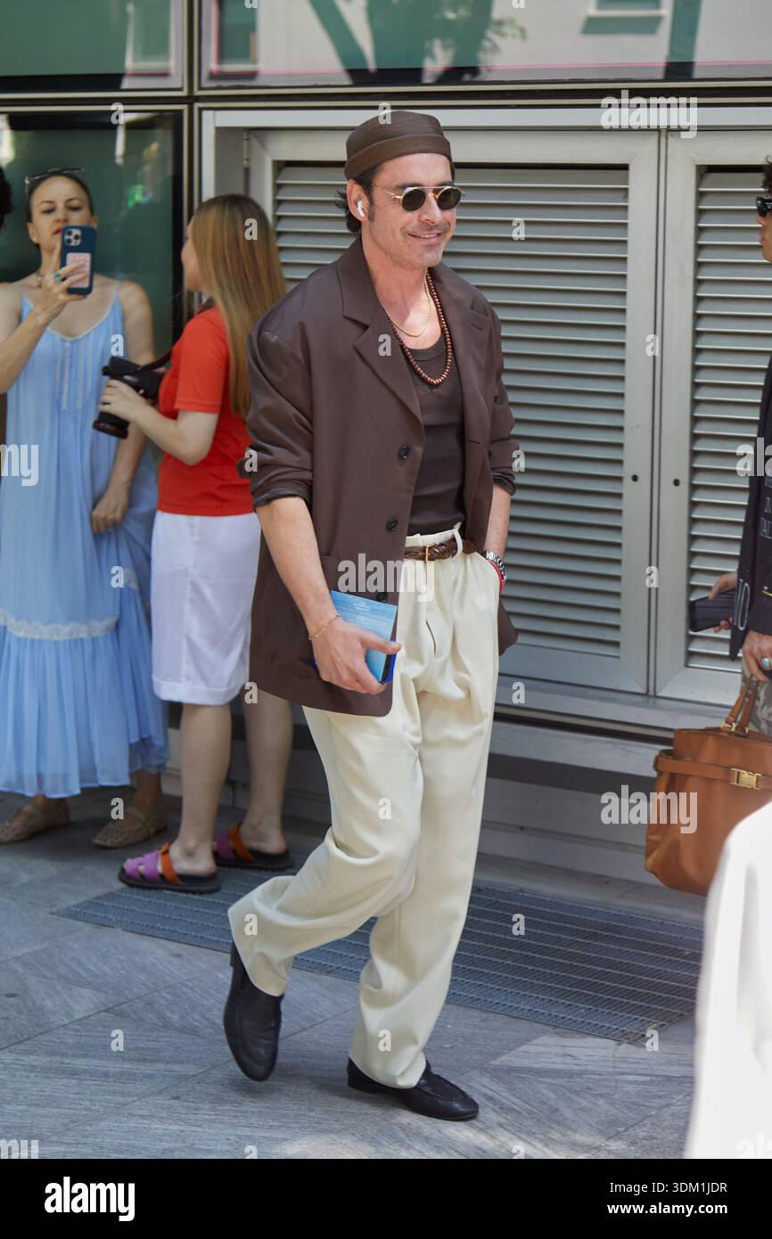 MILAN, ITALY - JUNE 23, 2025: Alex Badia with beige trousers and brown ...