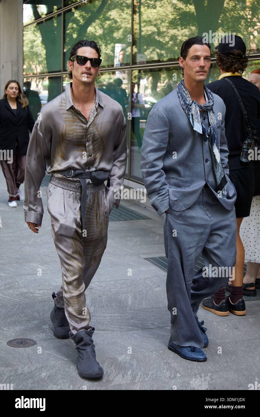 MILAN, ITALY - JUNE 23, 2025: Man with silk beige shirt and trousers ...