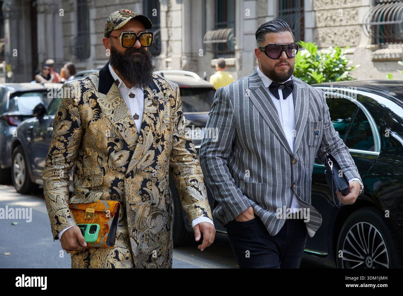 MILAN, ITALY - JUNE 21, 2025: Men with golden damask suit and grey ...