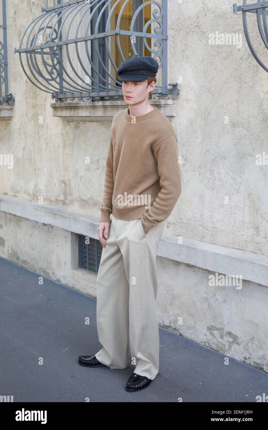 MILAN, ITALY - JUNE 22, 2025: Louis Powell with beige sweater and ...